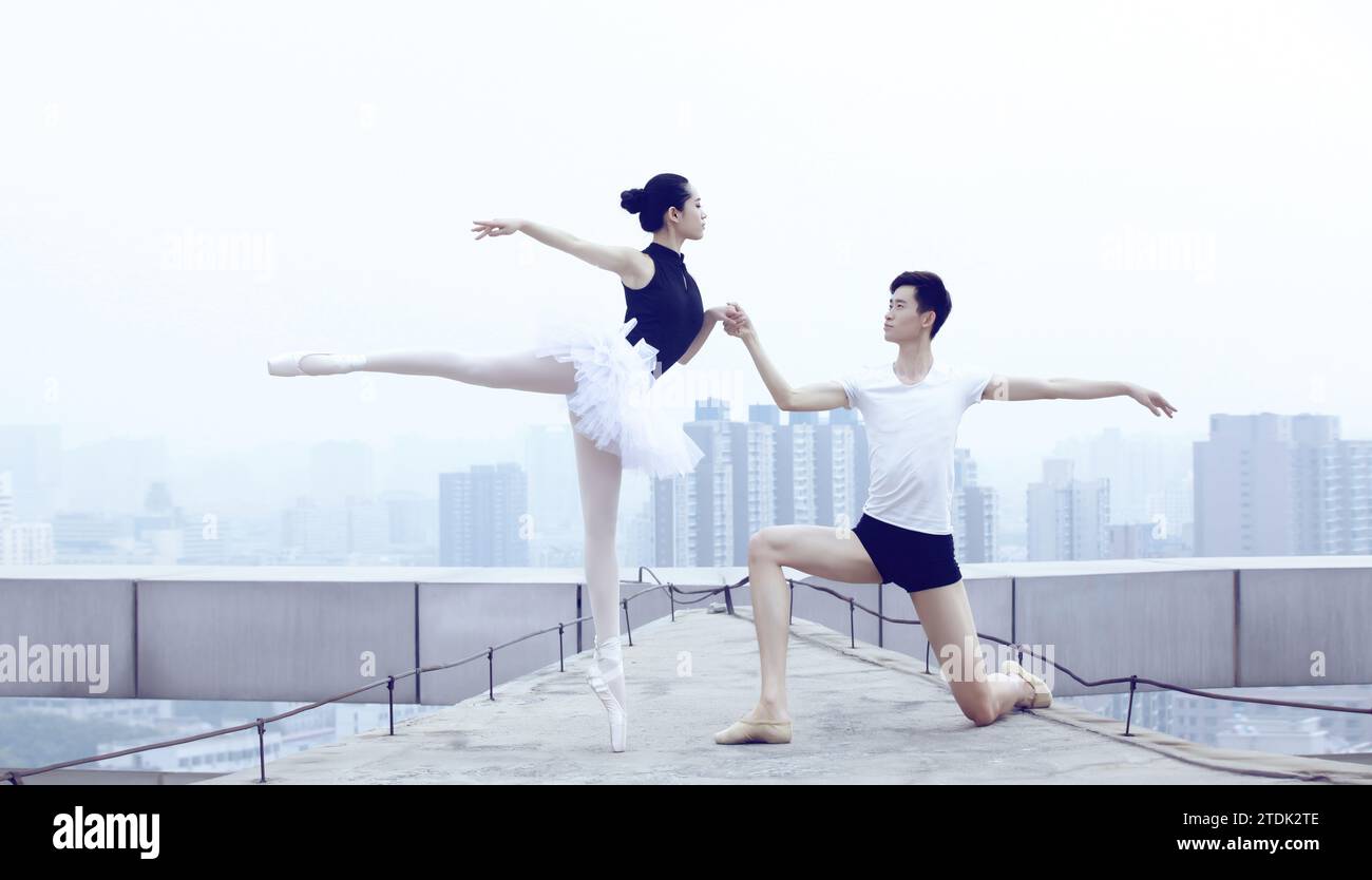 Couple dancing ballet in the dark studio Stock Photo - Alamy