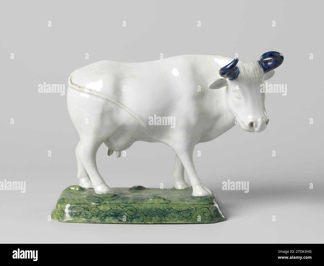 Cow with blue horns, rectangular pedestal with beveled corners ...