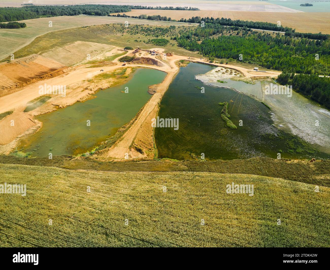 Open mining of construction sand from quarry by water ponds Stock Photo ...