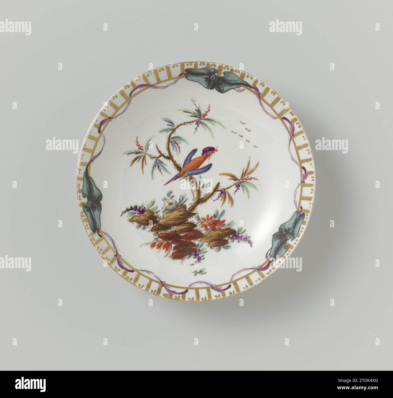 Saucer, polychrome painted with bird on a branch on the ground and edge ...