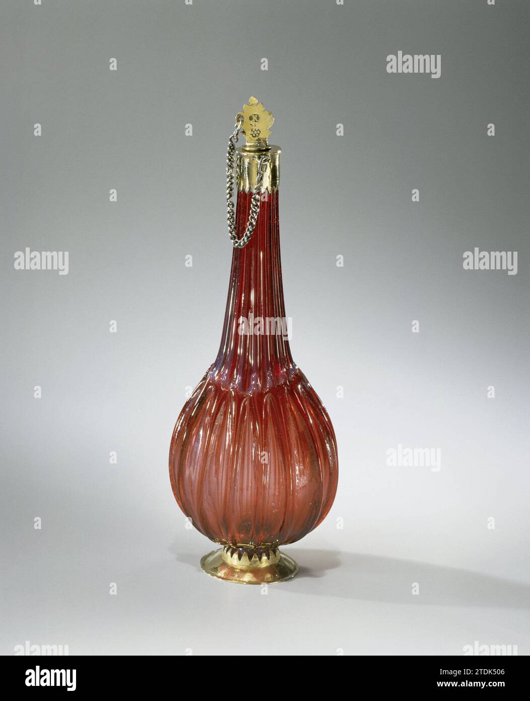 Bottle of ruby glass with flattened spherical body with vertical ribs ...