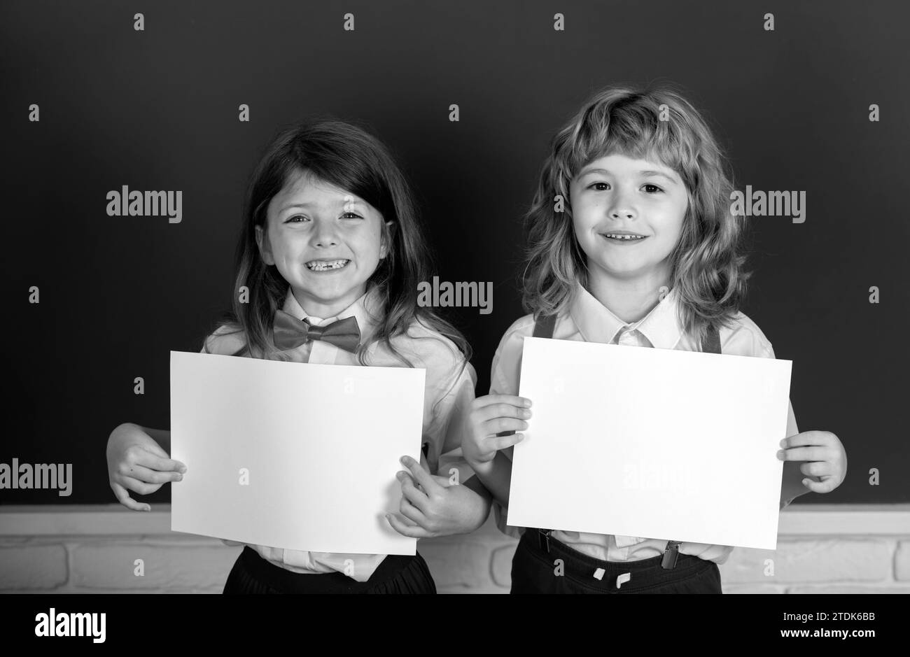 Cute little school kids friends studying together in classroom. Two ...