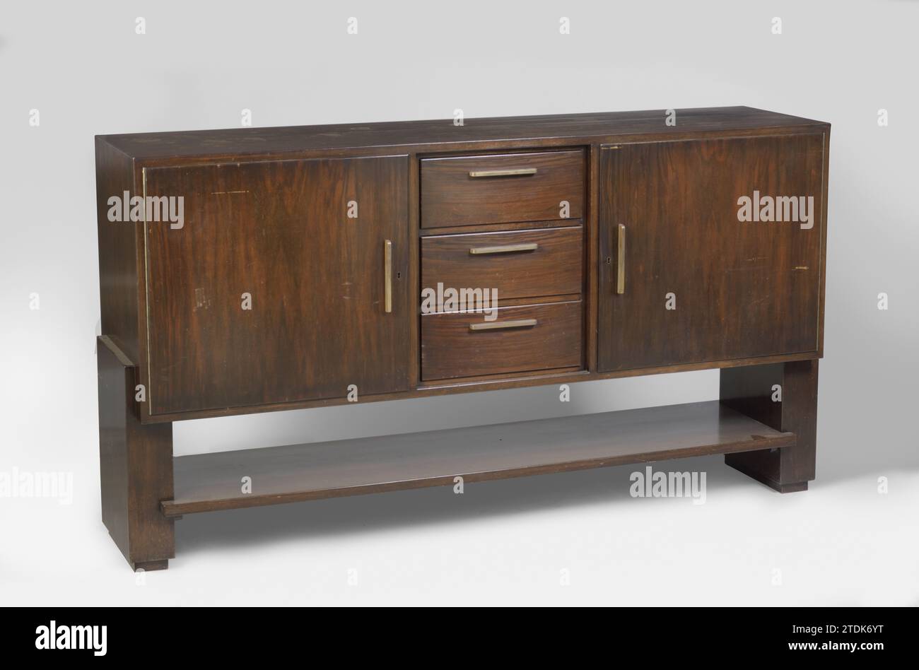 Buffet with two doors on either side of three drawers placed above each ...