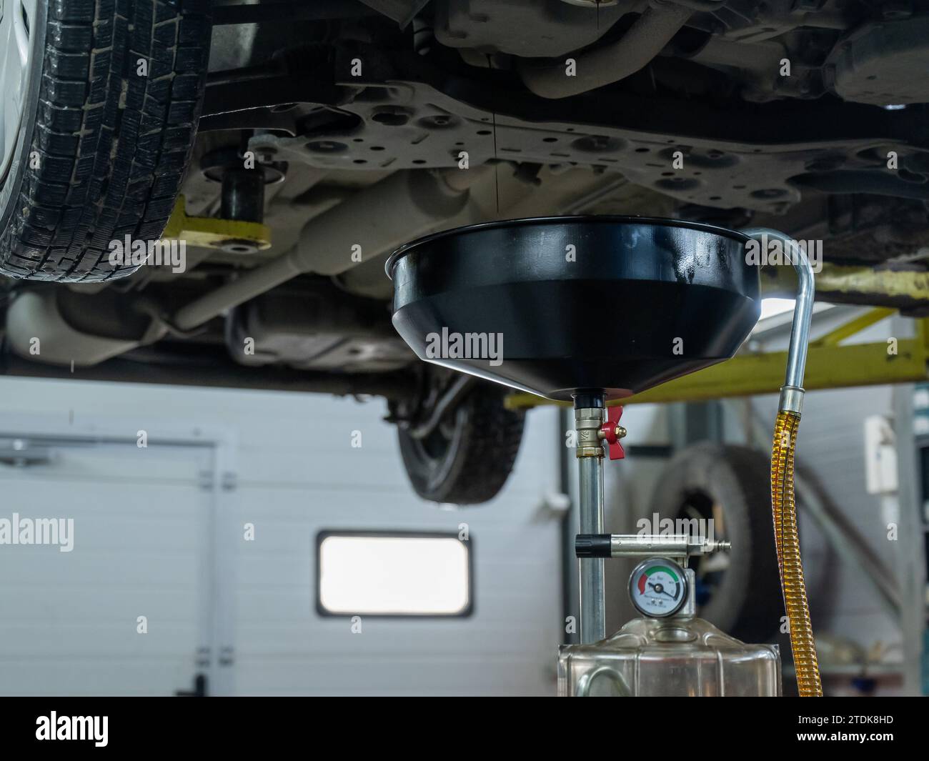 The process of changing the oil in a car engine. Draining old dark used ...