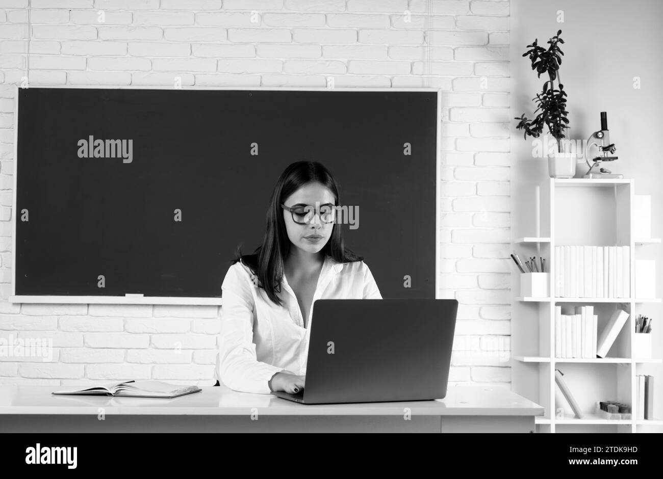 Female student with laptop computer on lesson lecture in classroom at ...