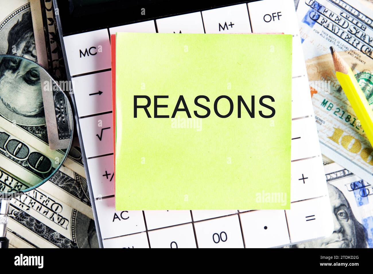 REASONS text, a word written on a sticker lying on a calculator against ...