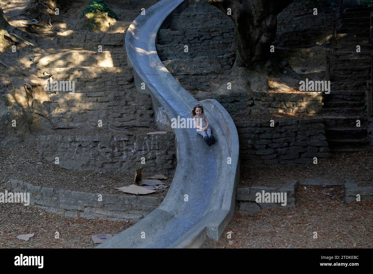 Aylah Levy, 6, rides down a concrete slide while interviewed with her ...
