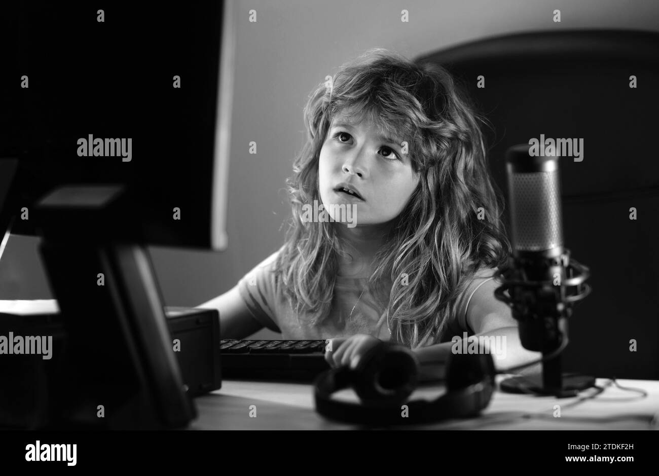 Cute preschool child watching video lesson by laptop. Little hacker ...