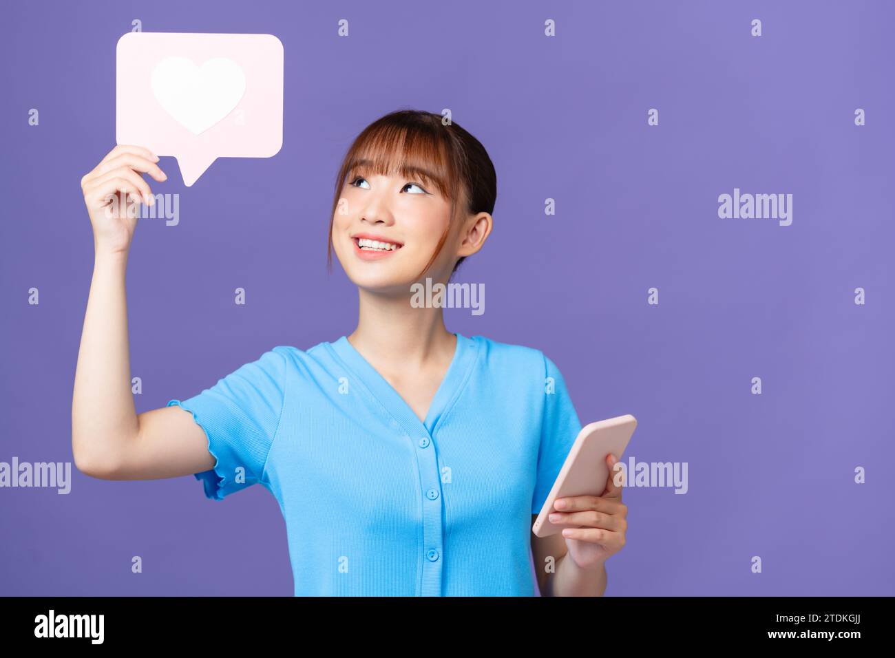 Young female student using cellphone showing like icon smiling isolated ...