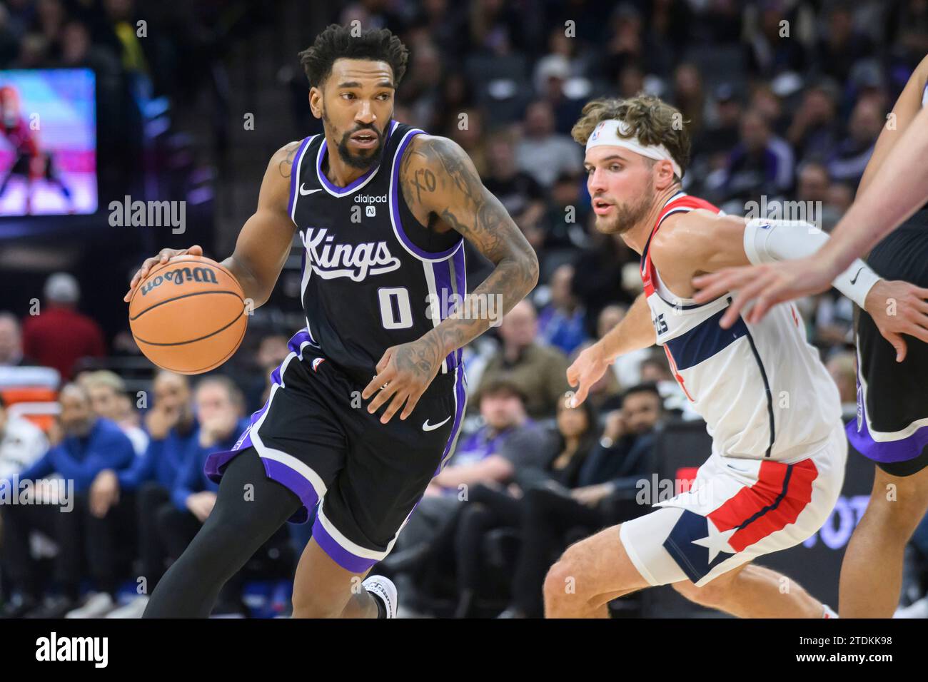 Sacramento Kings guard Malik Monk (0) drives past Washington Wizards forward Corey Kispert ...
