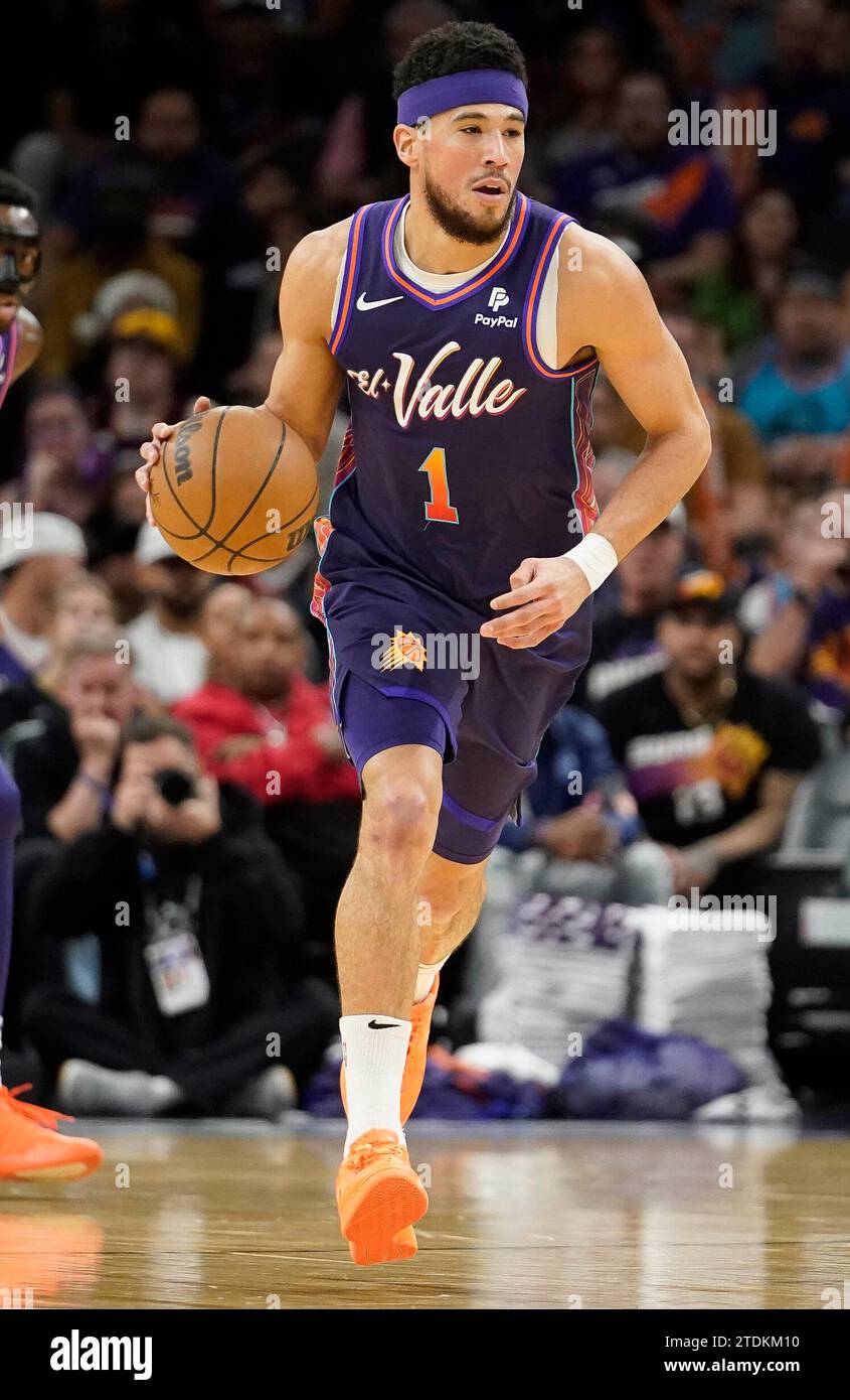 Phoenix Suns' Devin Booker (1) brings the ball up court against the ...