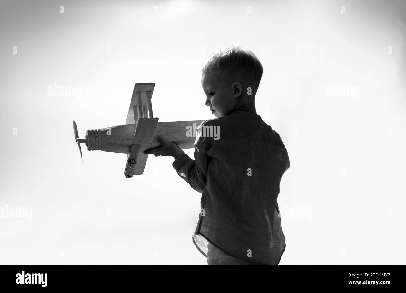 Child boy playing with wooden toy airplane, dream of becoming a pilot ...