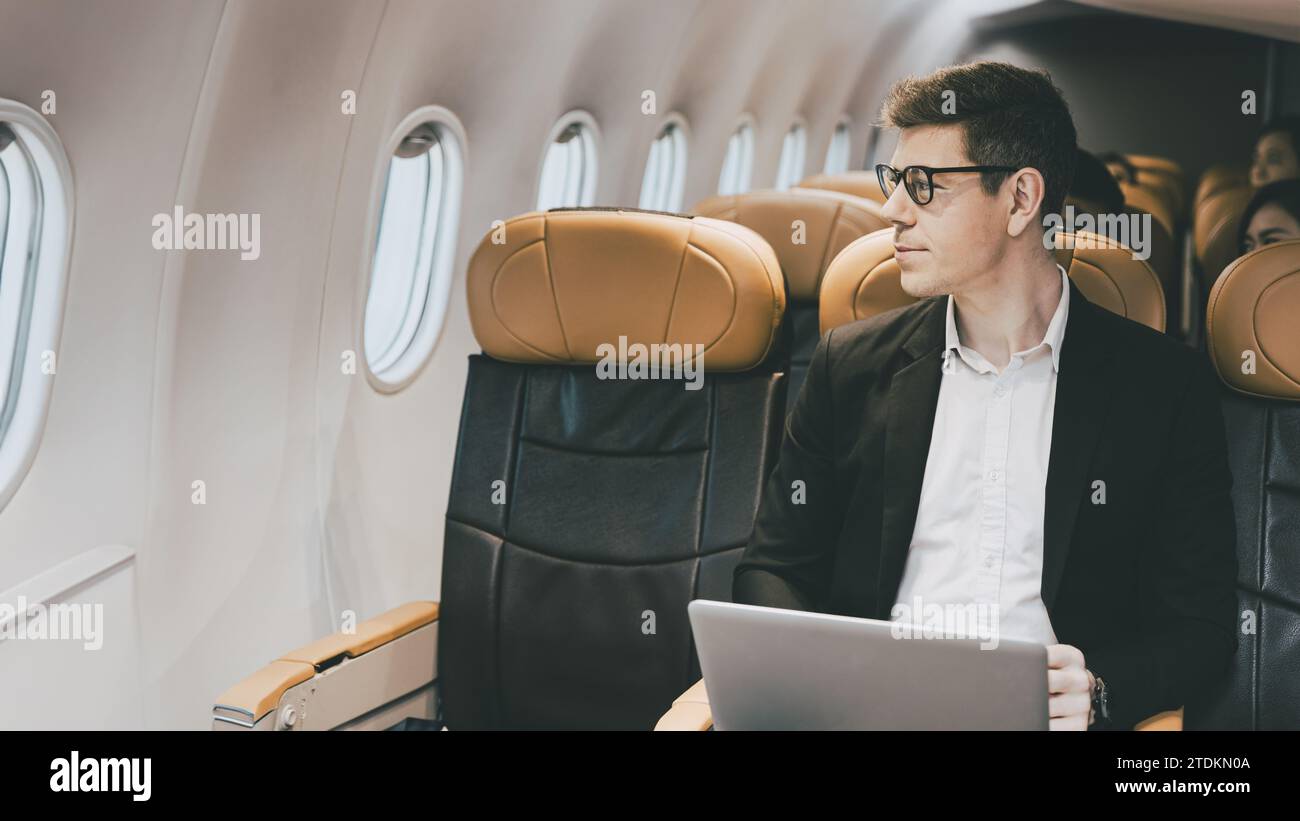 Businessman traveling by plane look at the window. Caucasian male ...