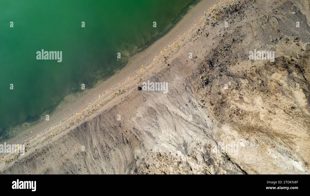 This aerial photograph captures the stark contrast between the lush ...