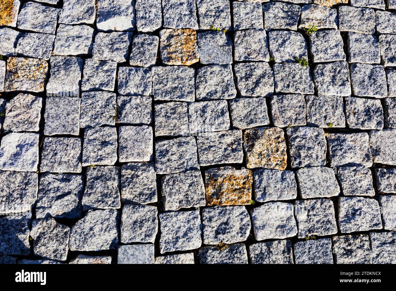 Top view on stone road close up. Old pavement of granite. Brown square ...