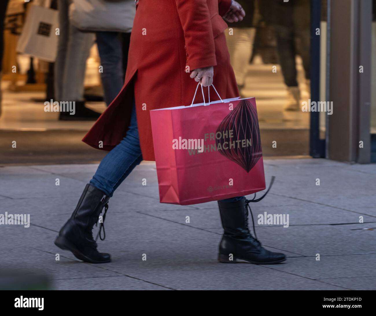 13 December 2023, Hesse, Frankfurt/Main: A passer-by carries a ...