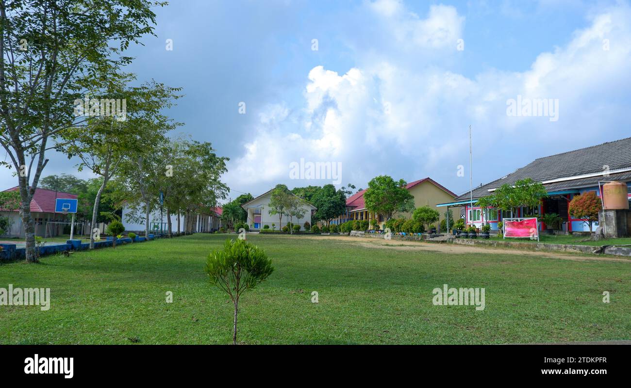 Natural View Of A School Yard With Green Grass And Several Buildings ...