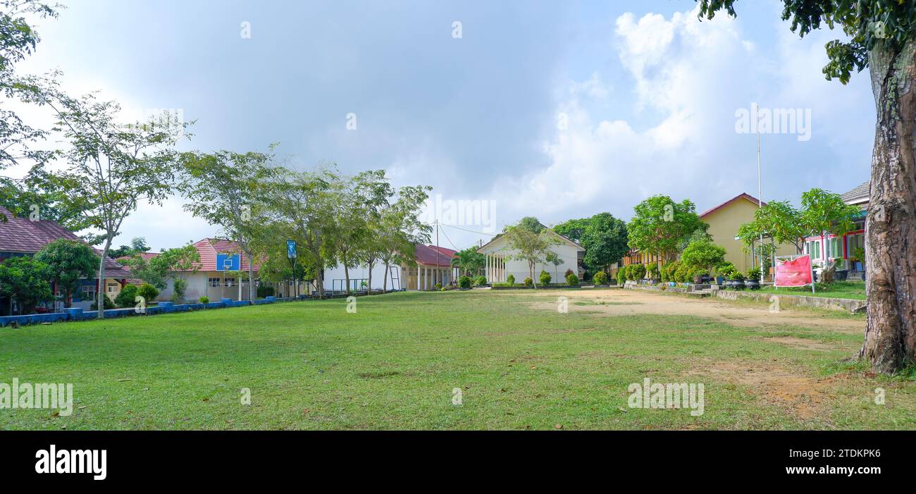 Natural View Of The School Yard With Green Grass And Several Buildings ...