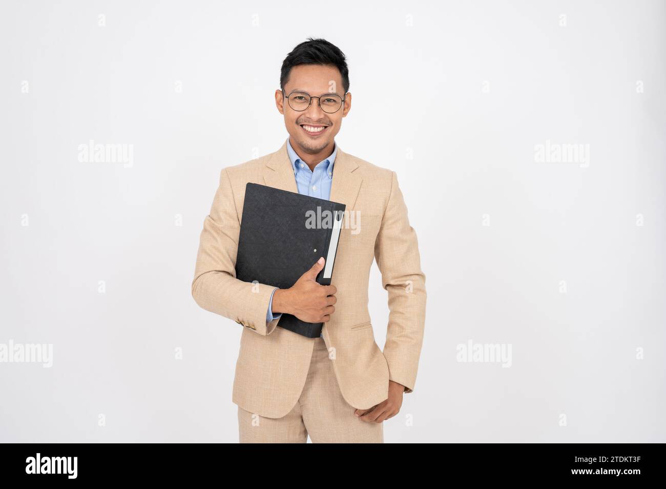 A smart and happy Asian businessman in a formal suit with a document ...