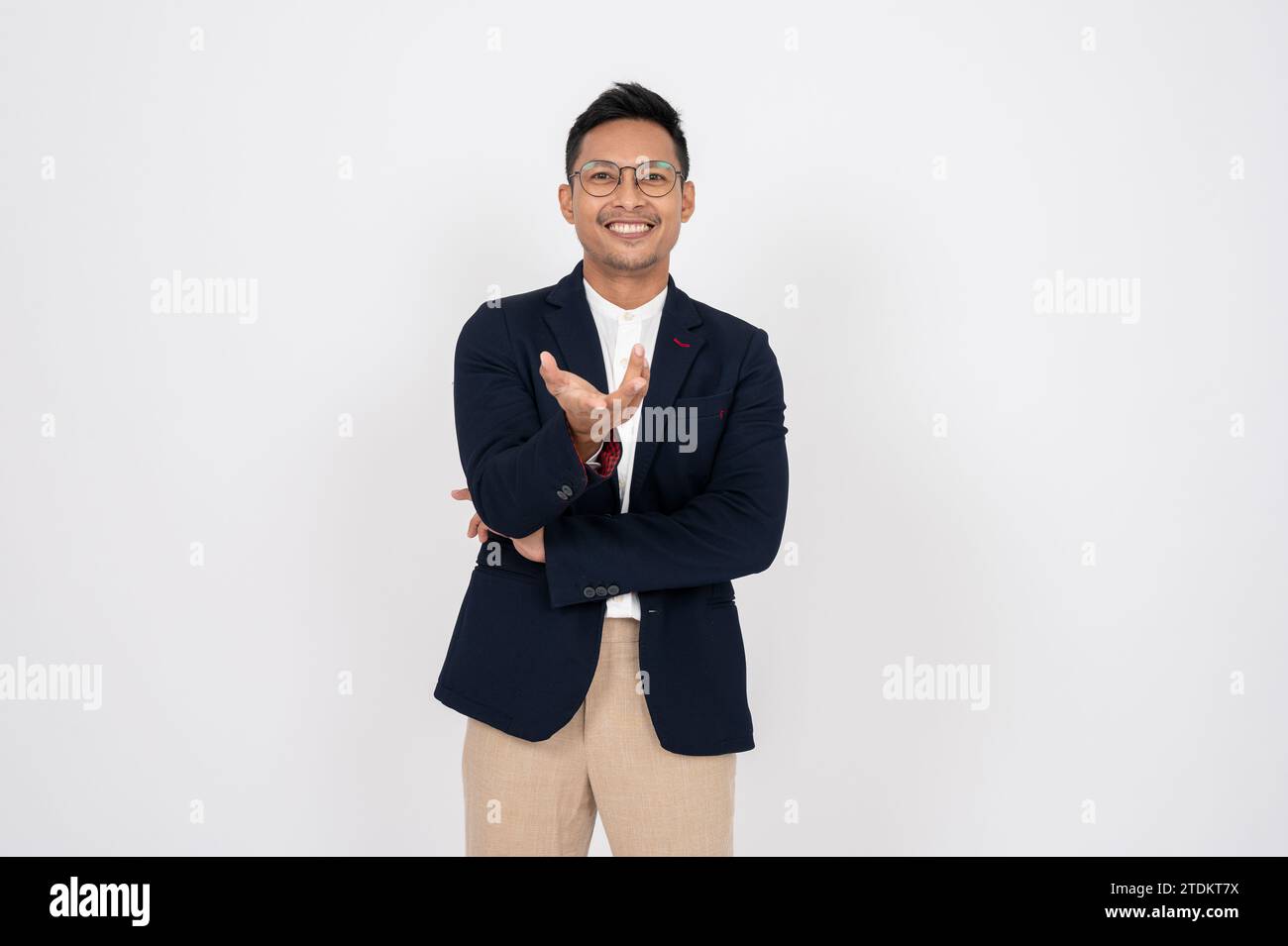 A positive Asian businessman is smiling and opening his palm at the ...