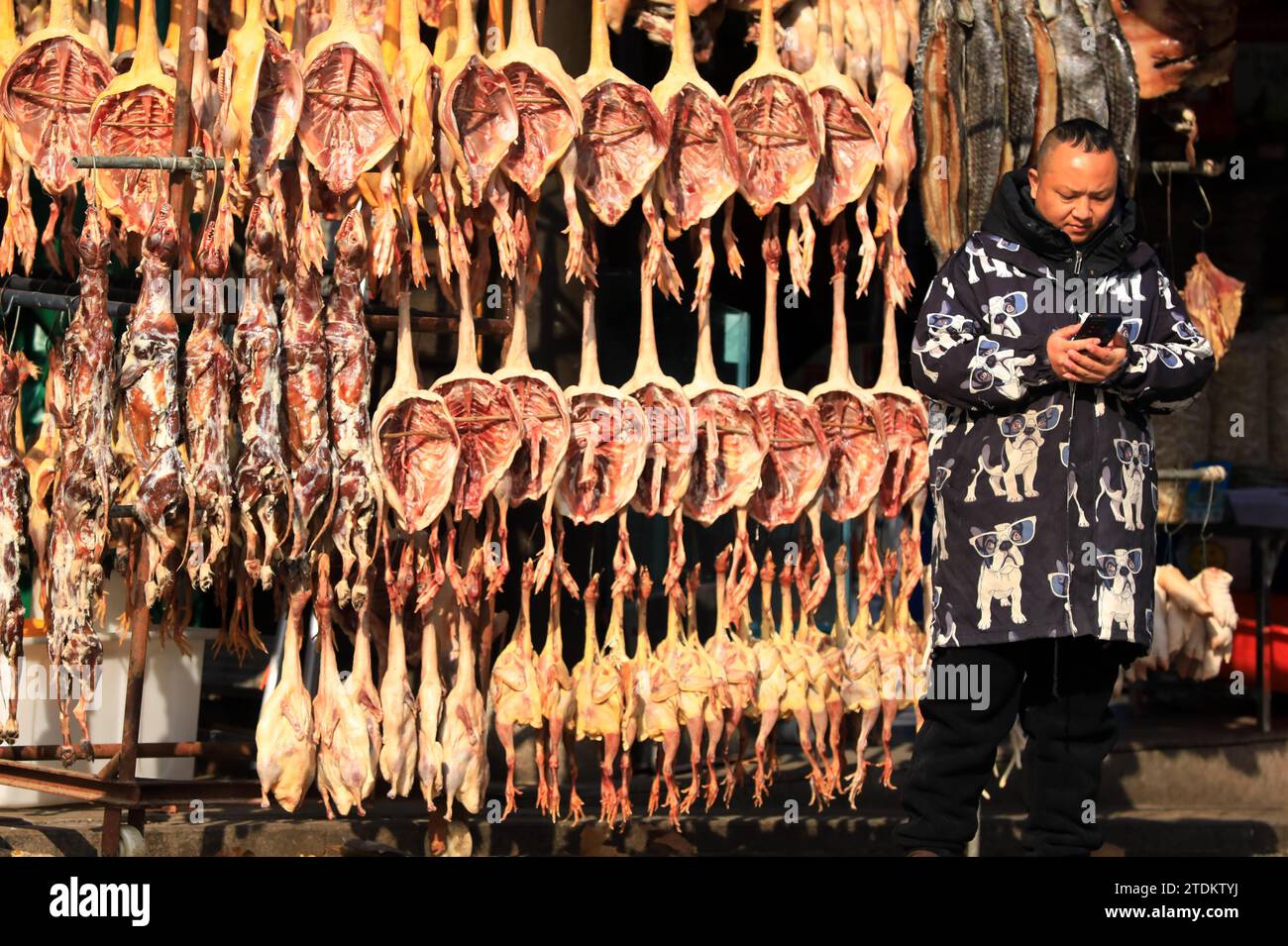 Strings of cured meat and fish are hung up in a market in Huai'an City ...