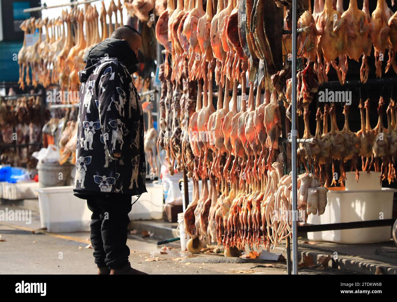 Strings of cured meat and fish are hung up in a market in Huai'an City ...