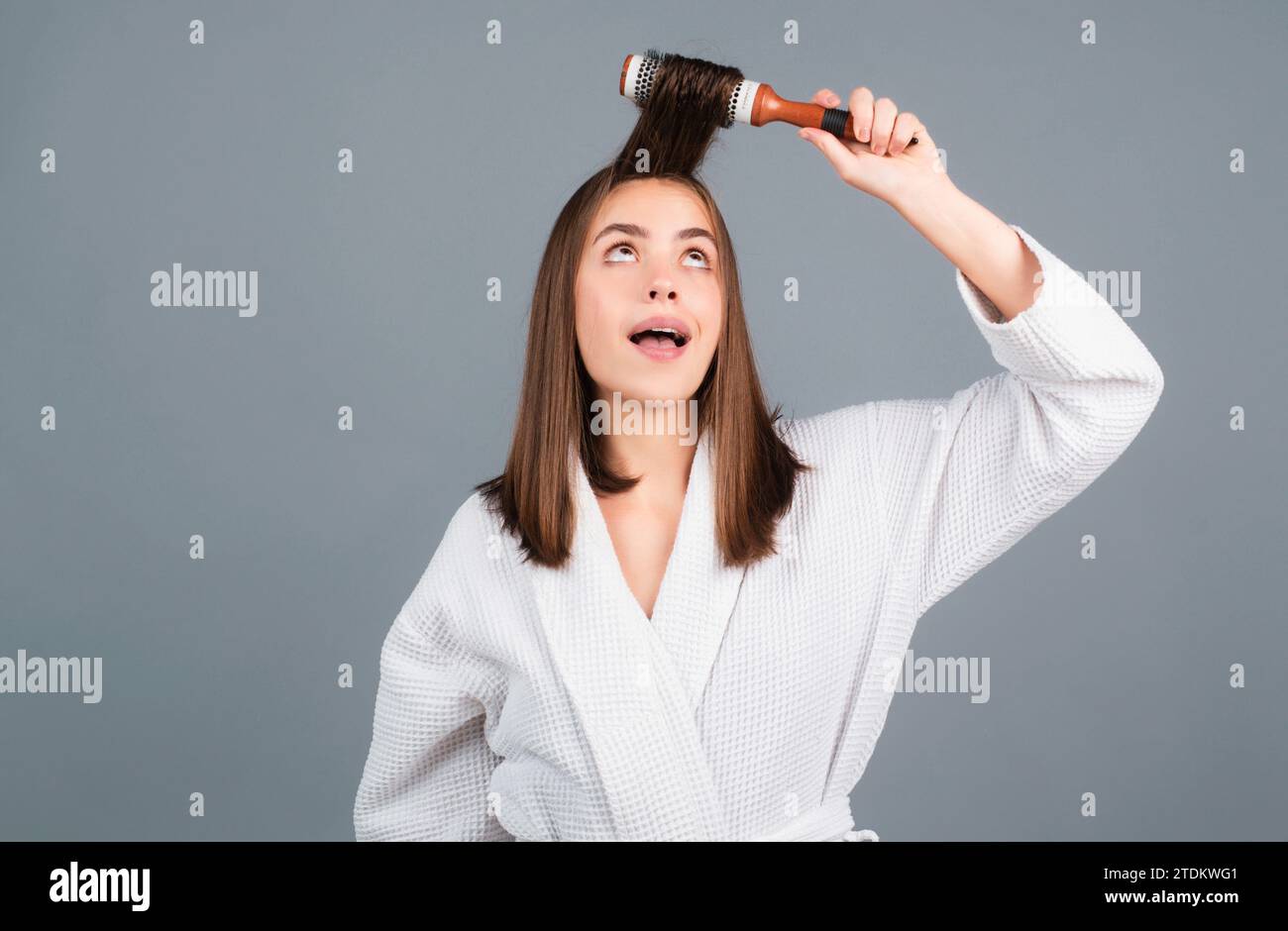 Surprised Woman Combing Hair Portrait Of Female Model With A Comb Brushing Hair Girl With