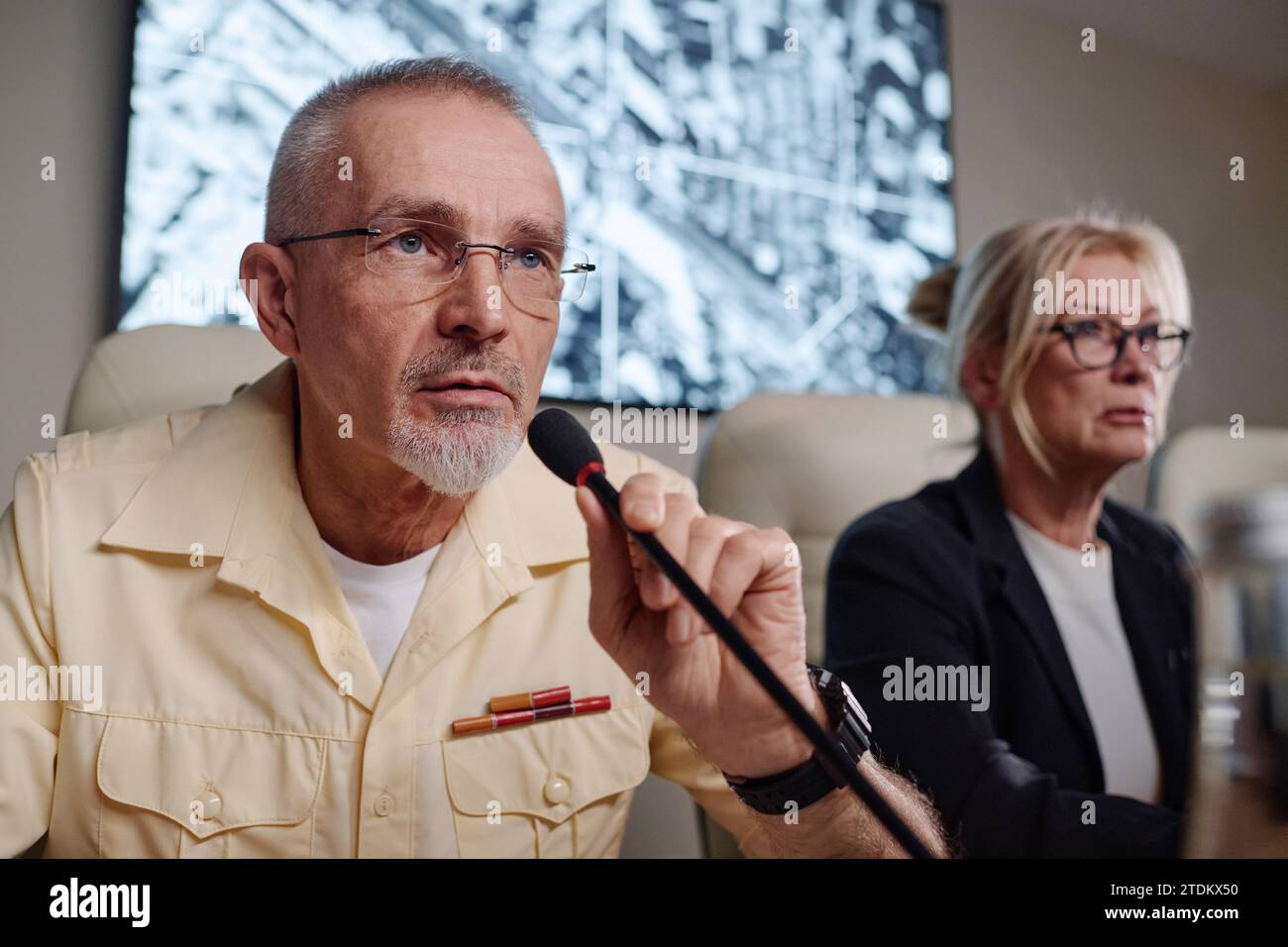Military man speaking in microphone while having conference with his ...