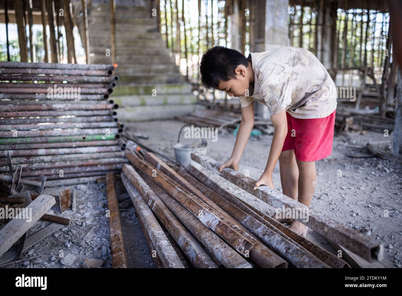 Children forced to work hard at construction site, child labor concept ...