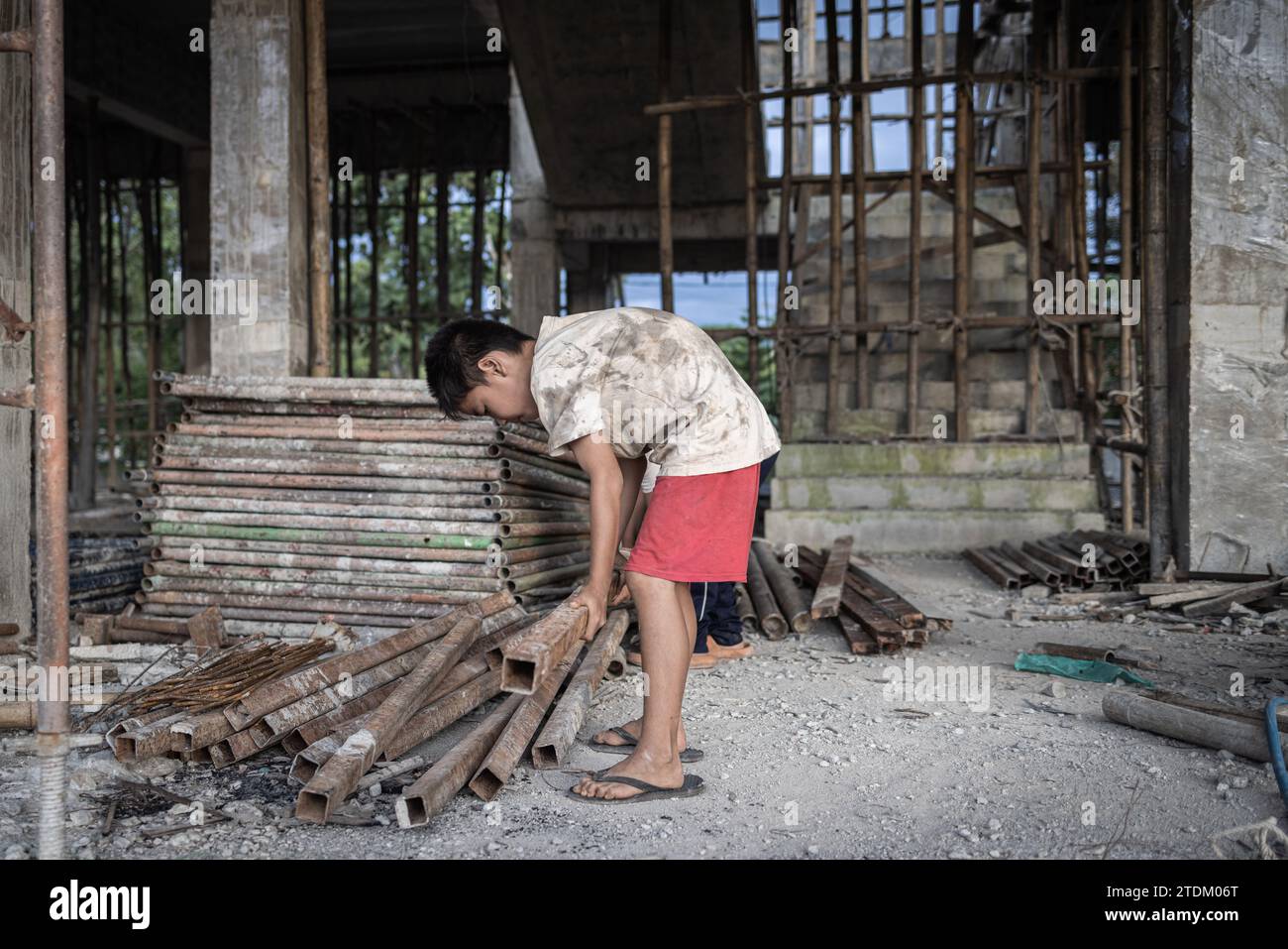 Children forced to work hard at construction site, child labor concept ...