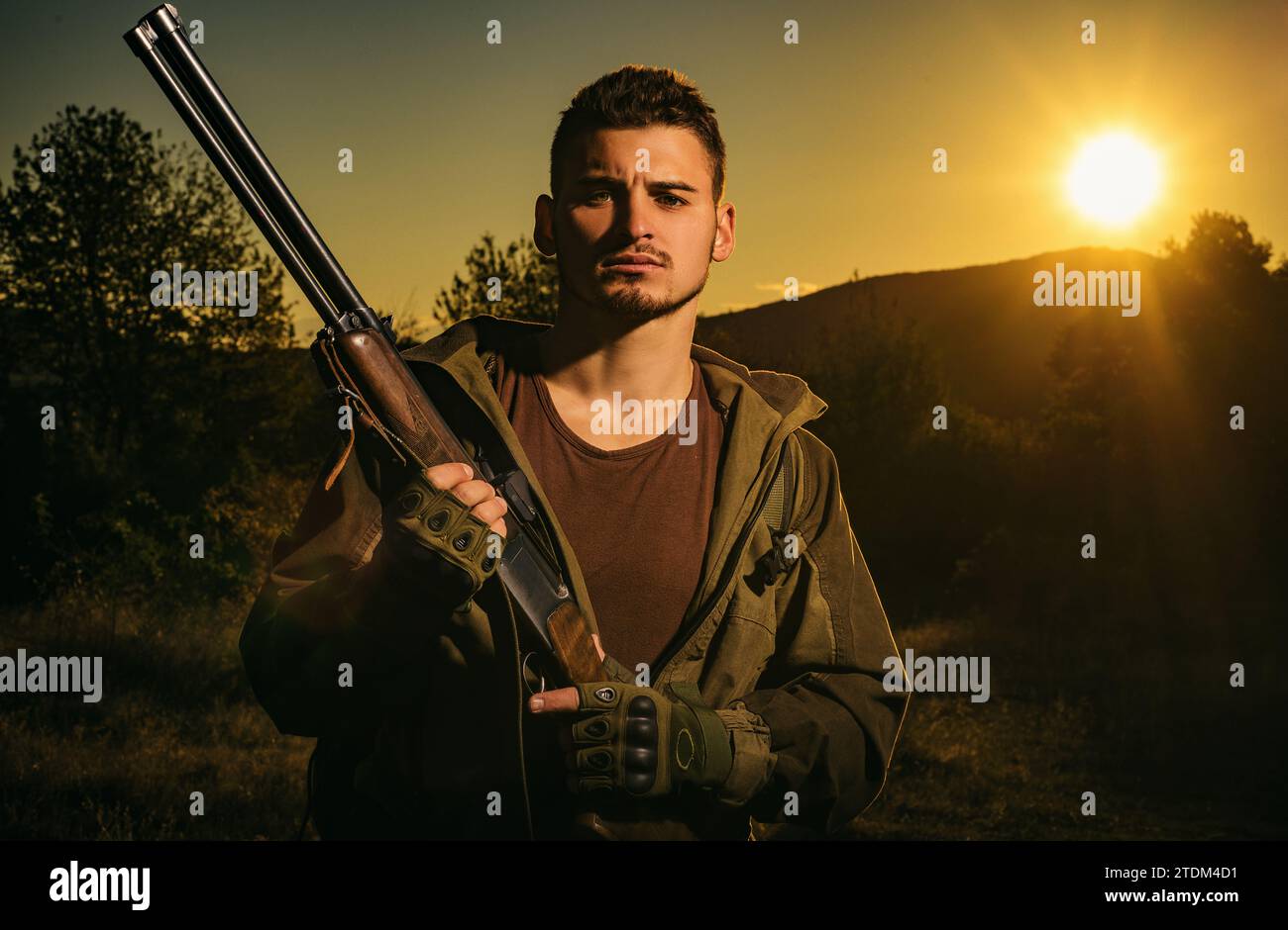 Hunter with Powerful Rifle with Scope Spotting Animals. Rifle Hunter ...