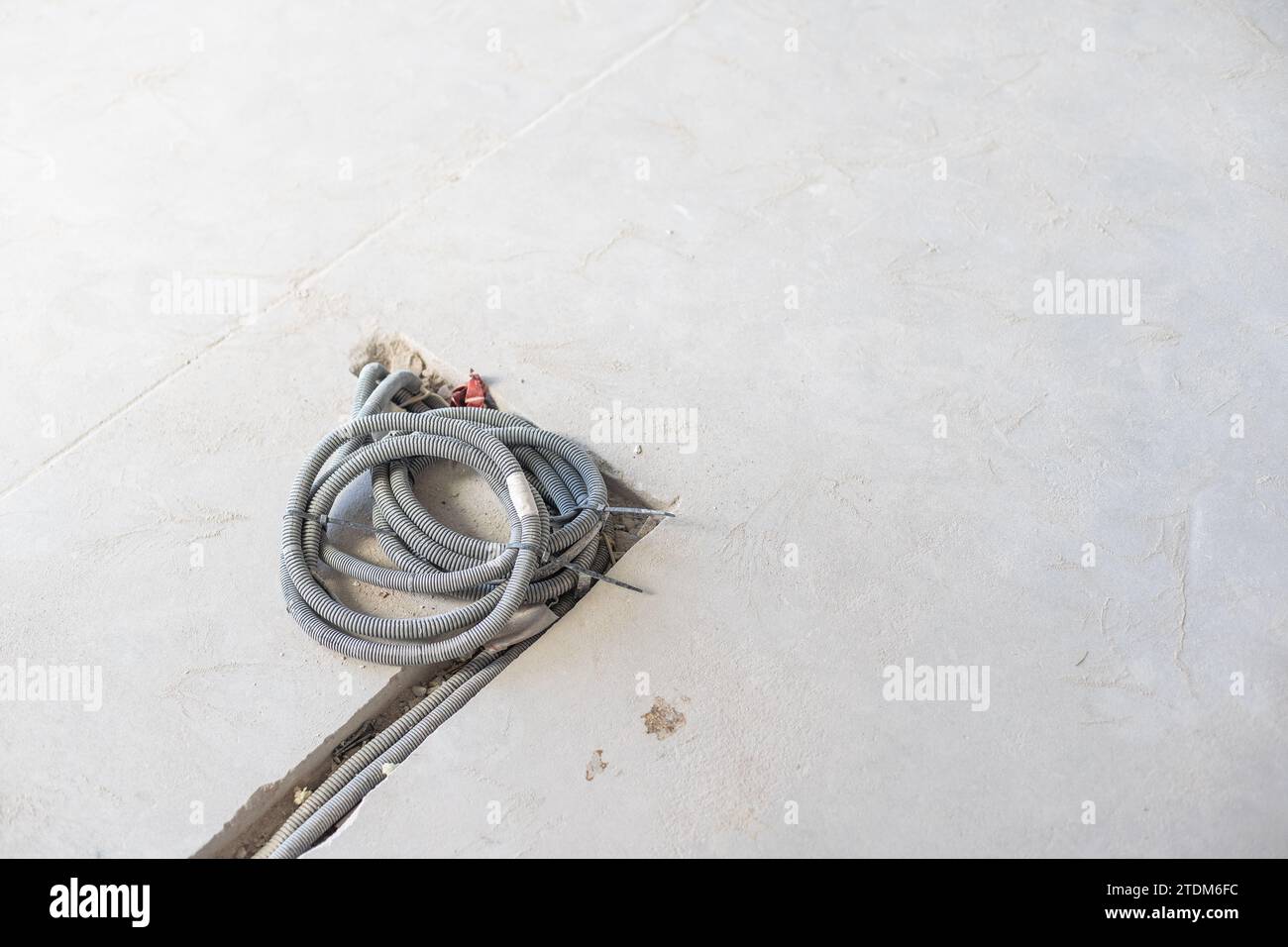 Rope hoist lifting steel frame with cement wall in the room Stock Photo ...