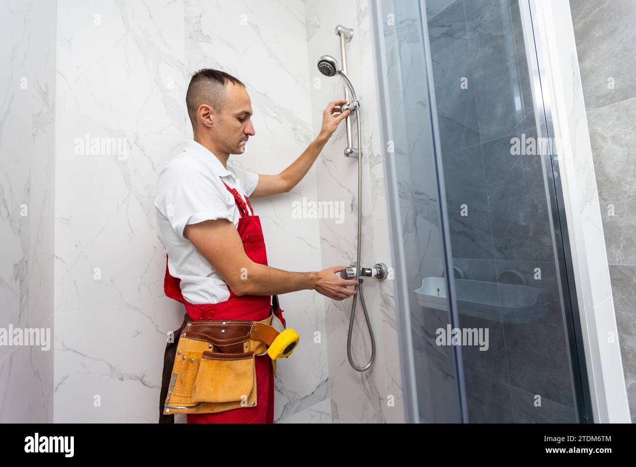 Workers are installing glass door of the shower enclosure Stock Photo ...