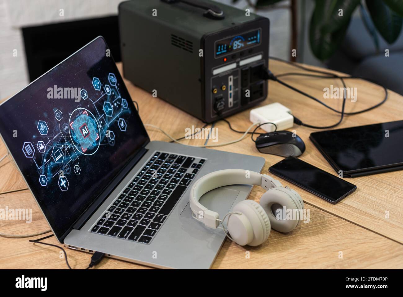 Portable power station charging gadgets near wall Stock Photo - Alamy