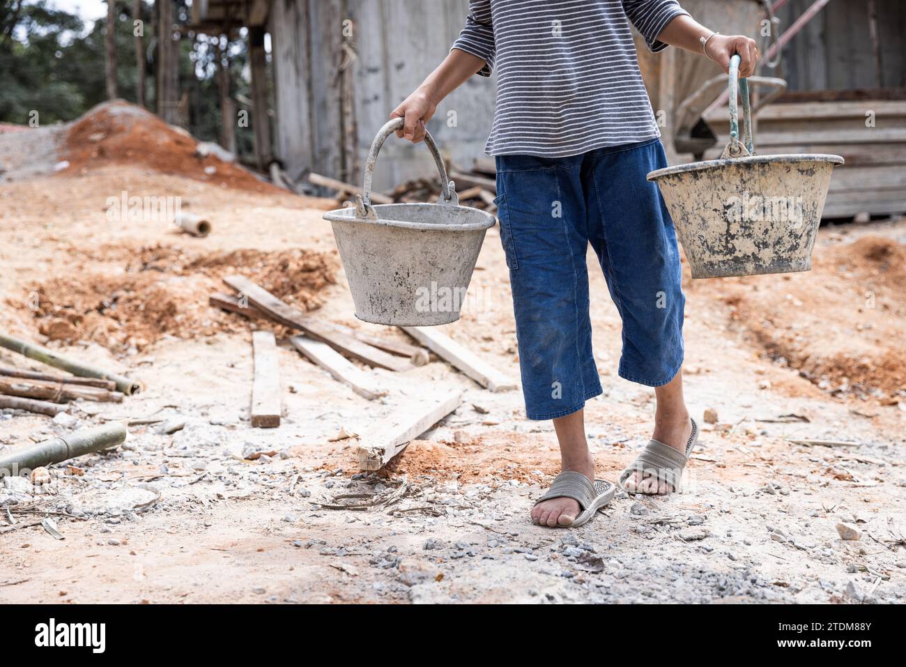 Children forced to work hard at construction site, child labor concept ...