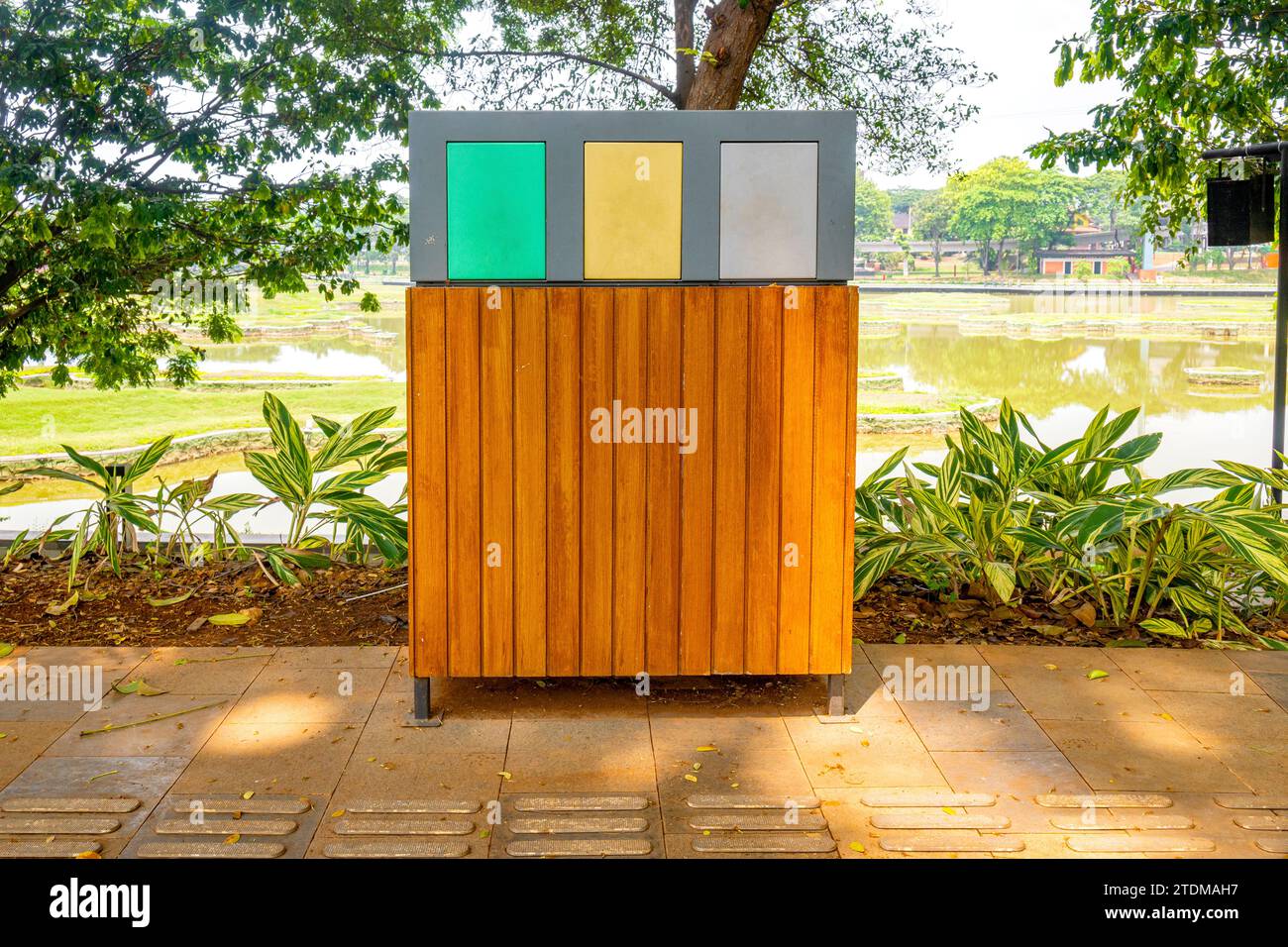 Garbage bins on the pathway in the park Stock Photo - Alamy