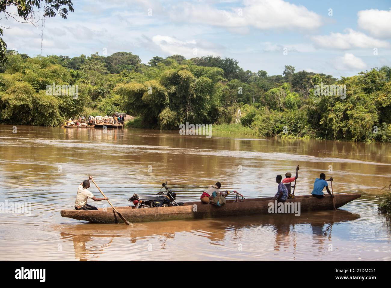 Transport of people across the Mbari river by locally made canoes and ...