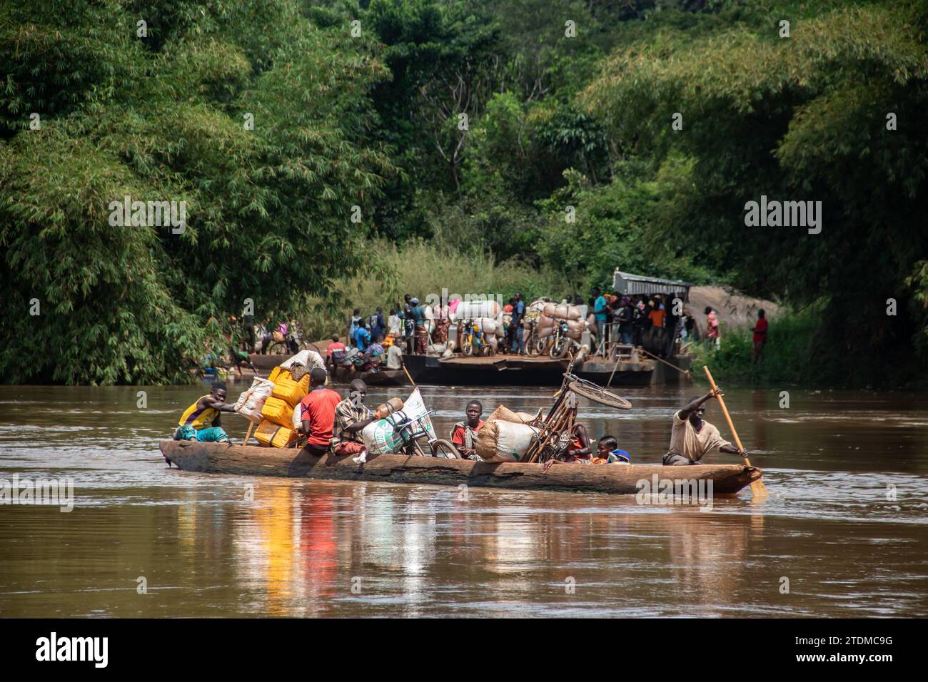 Transport of people across the Mbari river by locally made canoes and ...