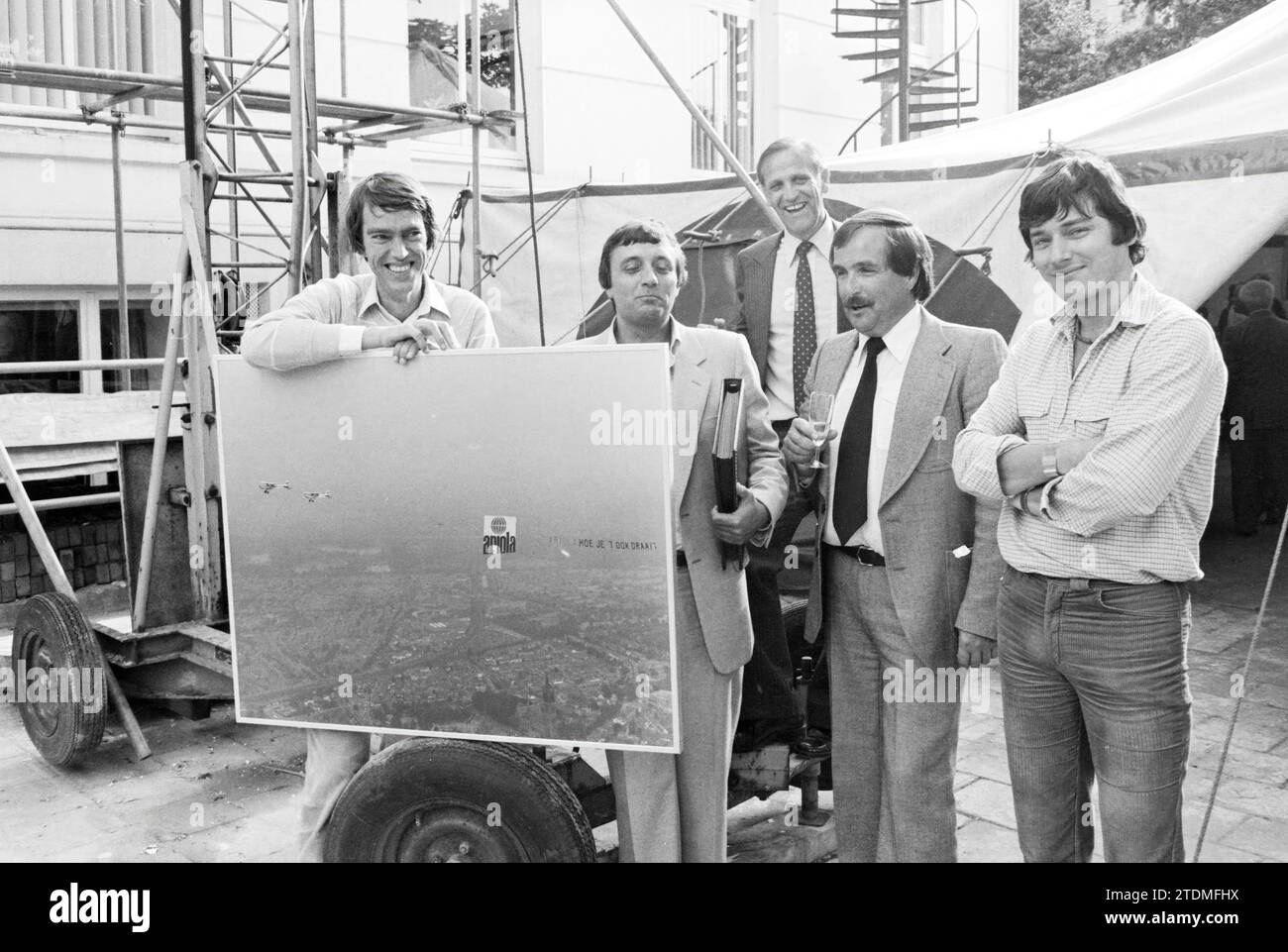 Five men with a poster of an airplane with air advertising for Ariola ...