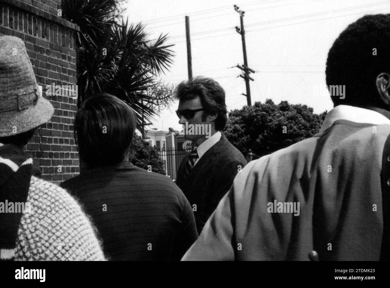 Director DON SIEGEL (at far left) and CLINT EASTWOOD on set location ...