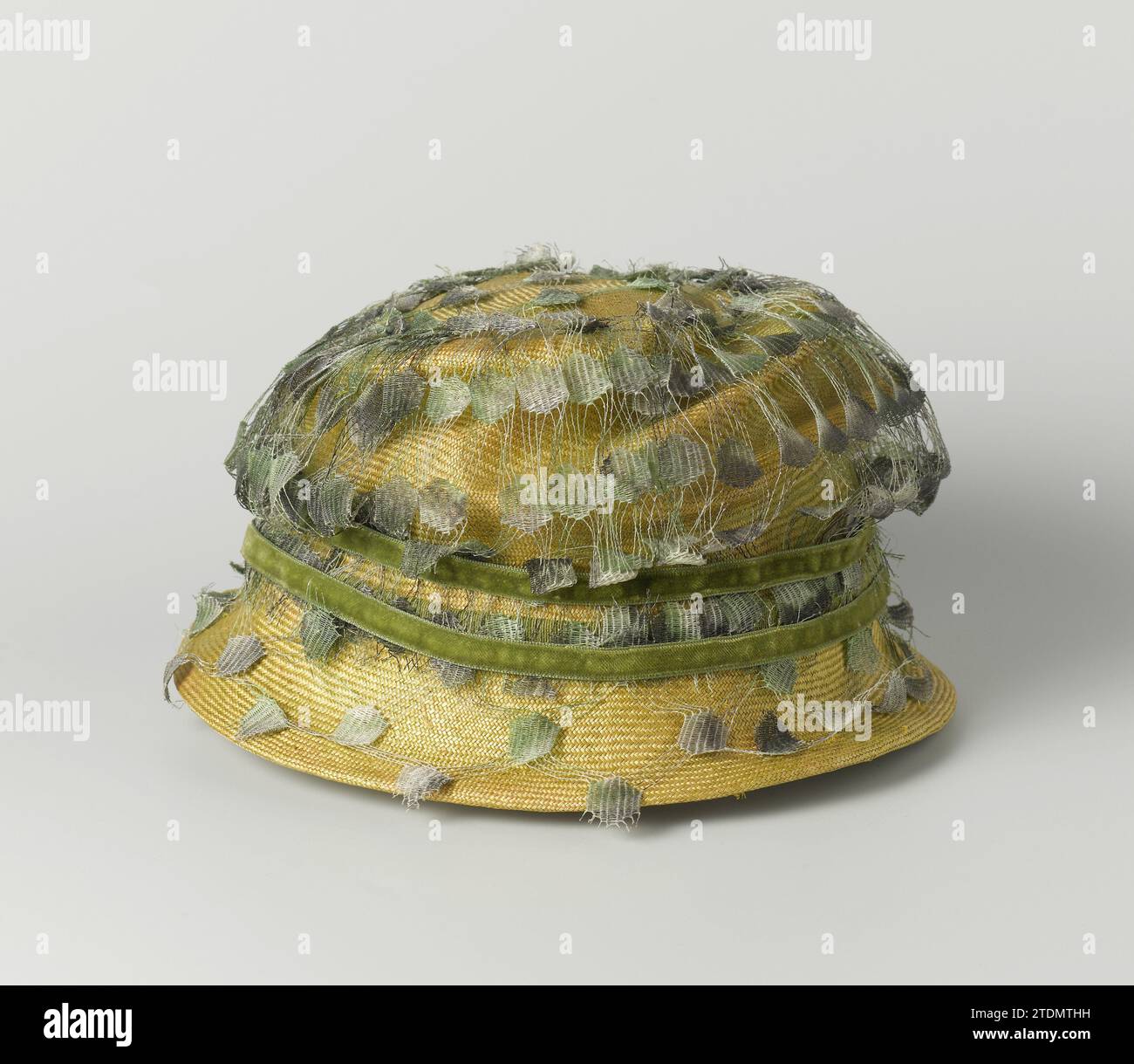Pot hat (cloche) of yellow straw over which green and gray openwork ...