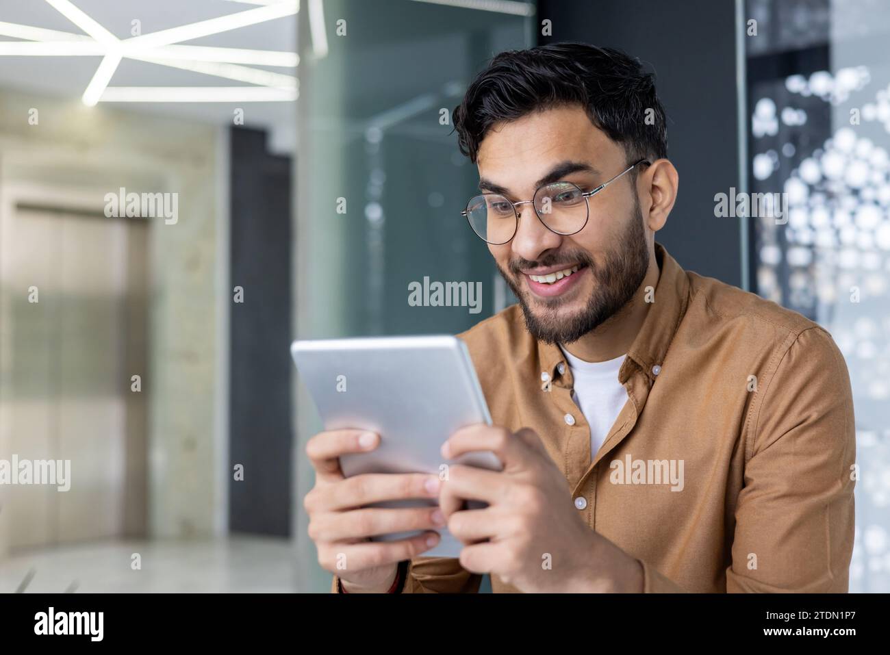 Young Hindu programmer close up inside office using application on ...