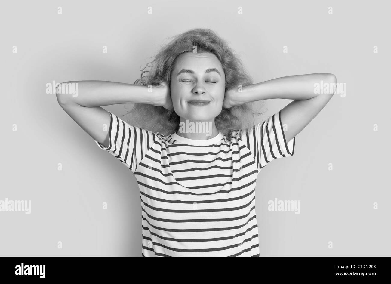 redhead girl hear loud noisy sound isolated on yellow background. young ...