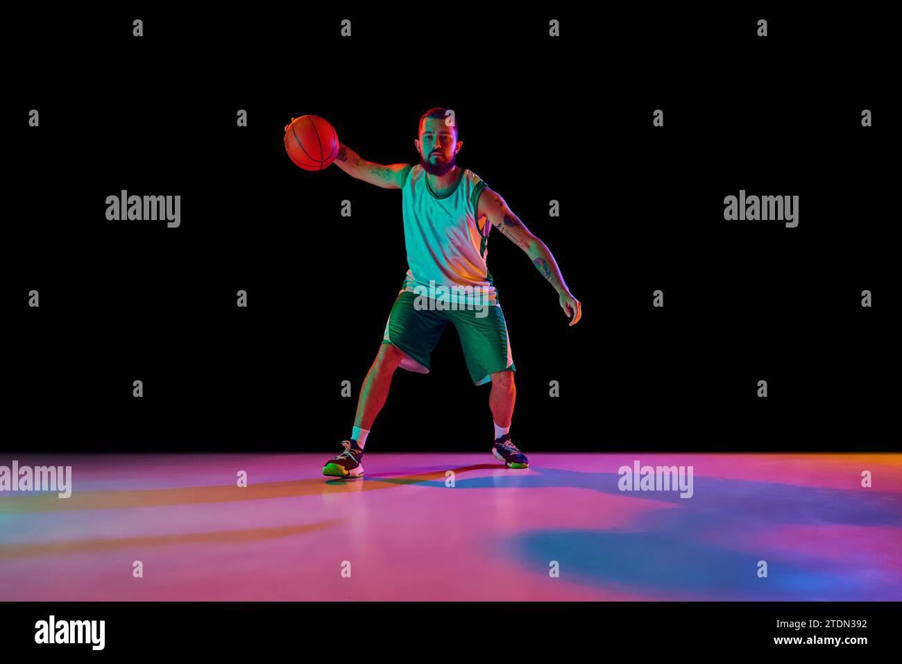 Dynamic portrait of professional basketball player honing skills with ...