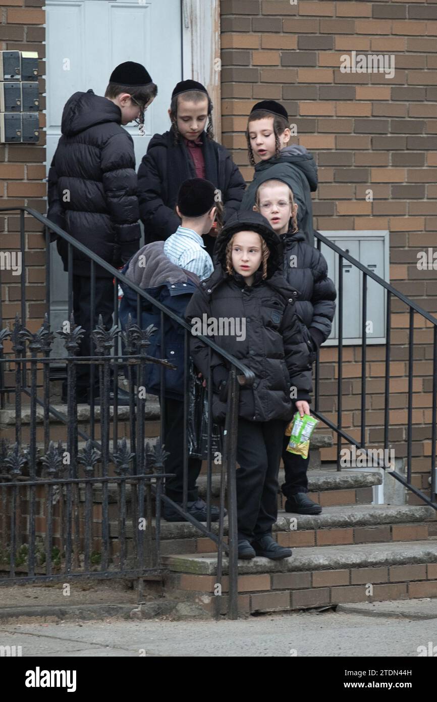 Hasidic Jewish boys wait for their school bus on a stoop in Brooklyn ...