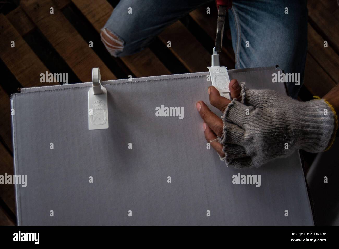 BALLOT BOX ASSEMBLY FOR THE 2024 ELECTION An officer puts a seal on the ...