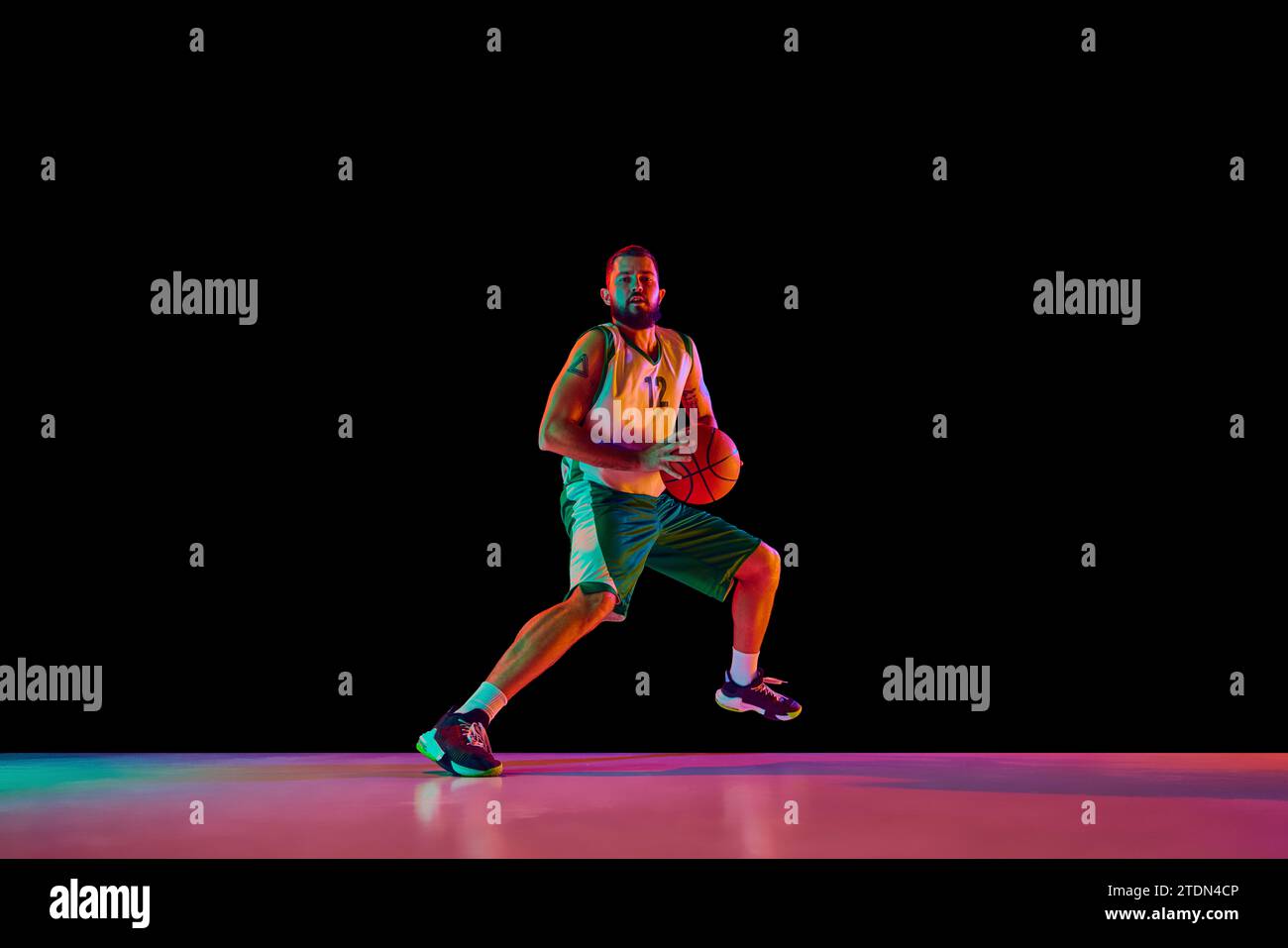 Basketball player, athletic man executing perfect slam dunk ...