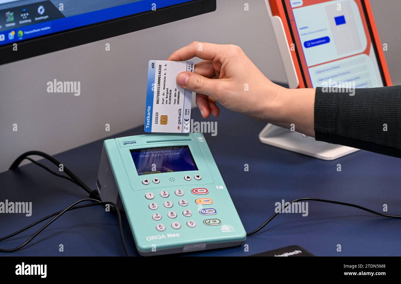 13 December 2023, Berlin: A health card is inserted into a reader in ...