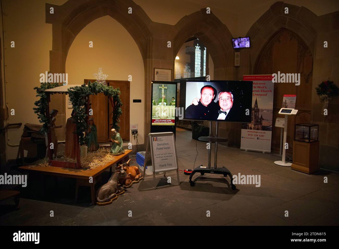 A photo is displayed on a screen ahead of the funeral for former ...