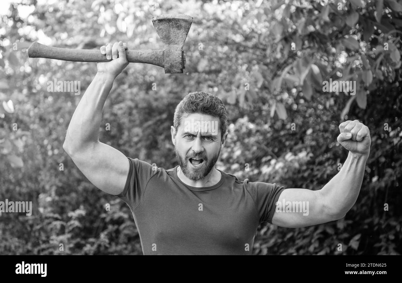 aggressive man with axe wearing shirt. aggressive man with axe outdoor ...